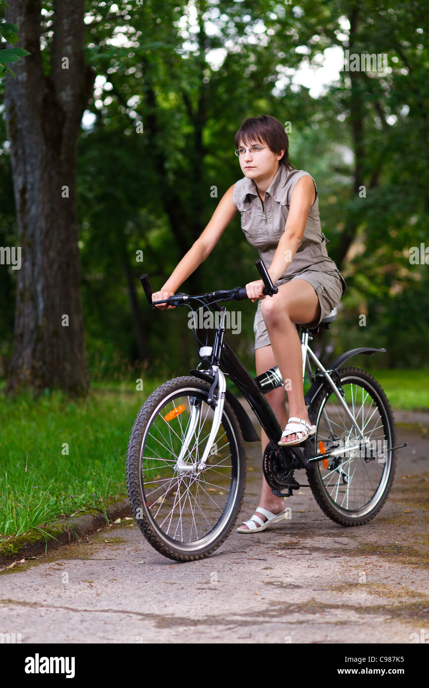 Girl on bicycle in a park Stock Photo - Alamy