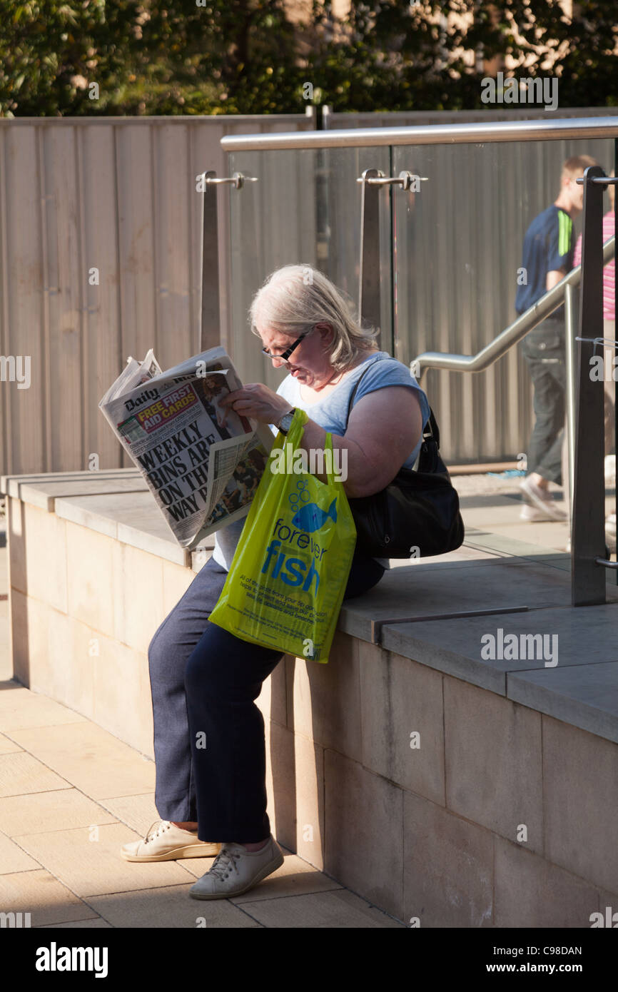 Woman reading a copy of the Daily Mail, Sheffield UK Stock Photo - Alamy