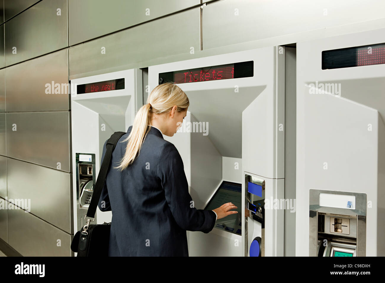 Businesswoman buying train ticket Stock Photo - Alamy