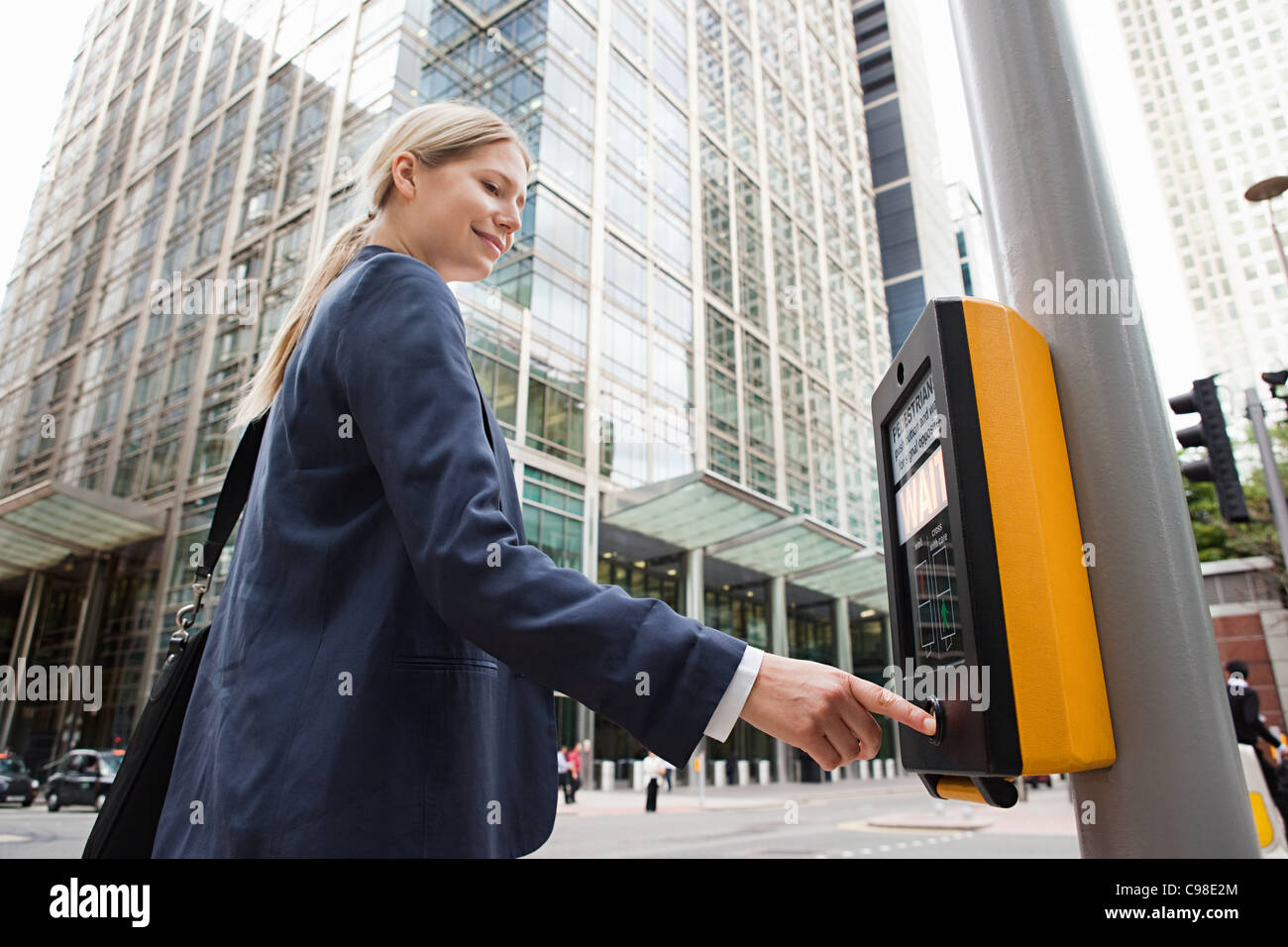 Businesswoman using pedestrian crossing Stock Photo - Alamy