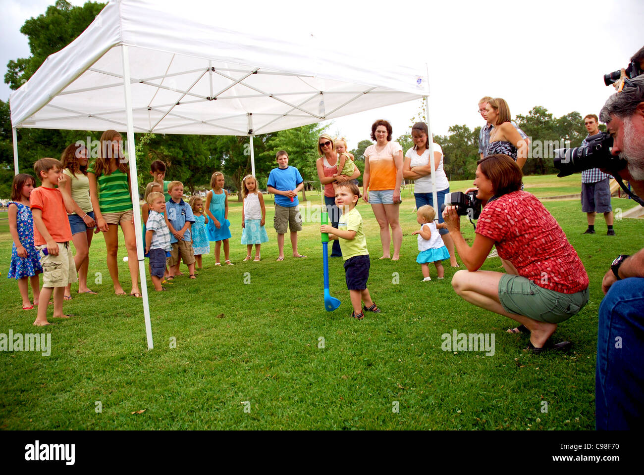 Photographers shooting pictures of a group of children Stock Photo - Alamy