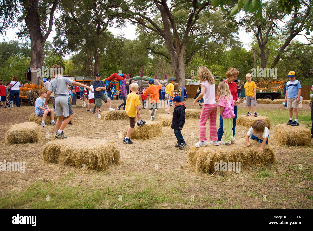 Kids jumping on hay bales at a pumpkin farm Stock Photo - Alamy