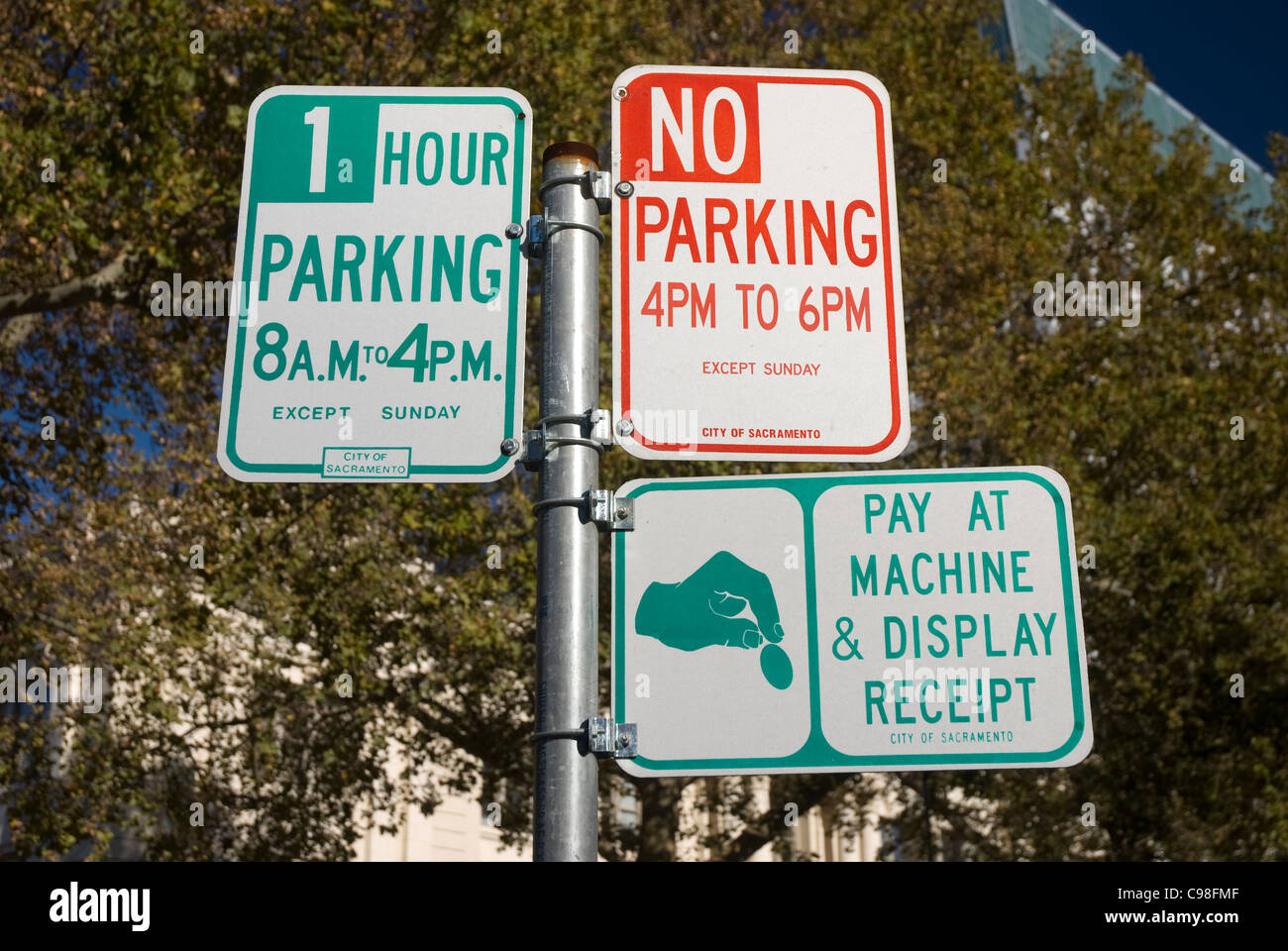 Three parking signs on one pole in Sacramento, California Stock Photo ...