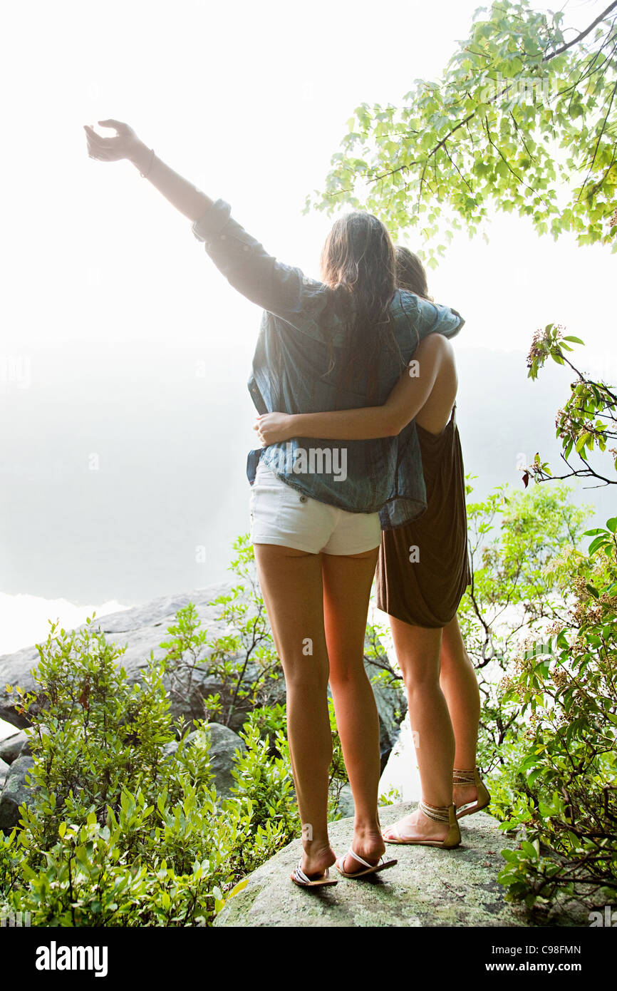 Young women looking over lake Stock Photo - Alamy