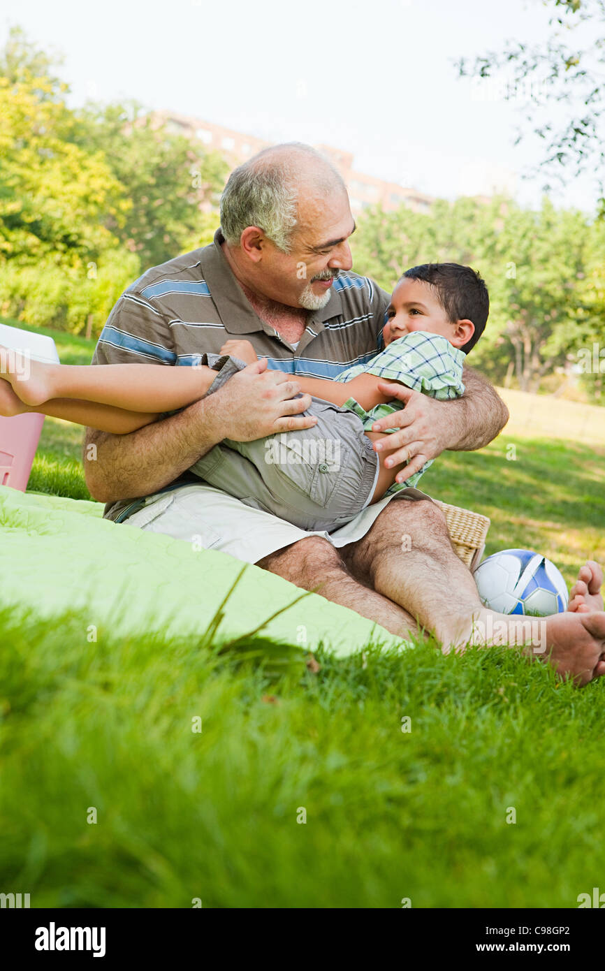 Grandfather playing with grandson park Stock Photo - Alamy