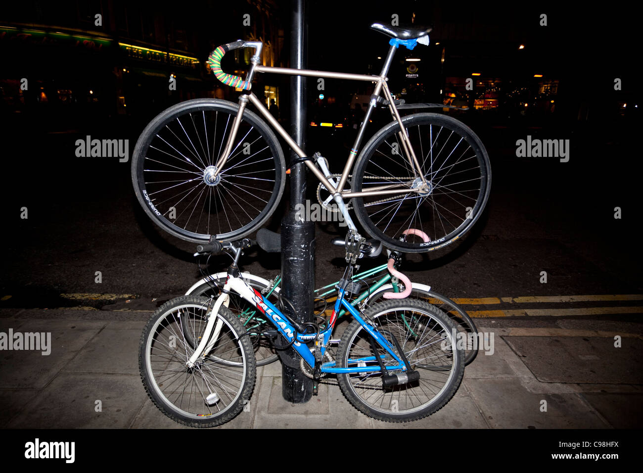 Bicycles chained to a post, London, England, UK Stock Photo - Alamy