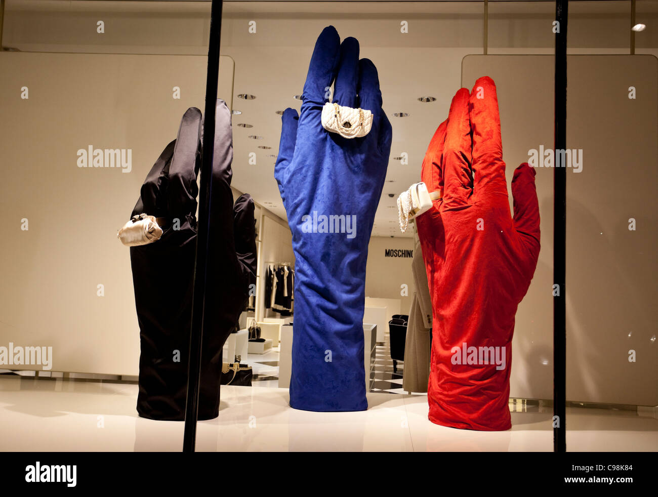 Giant mannequin hands wearing gloves in a shop window Stock Photo - Alamy