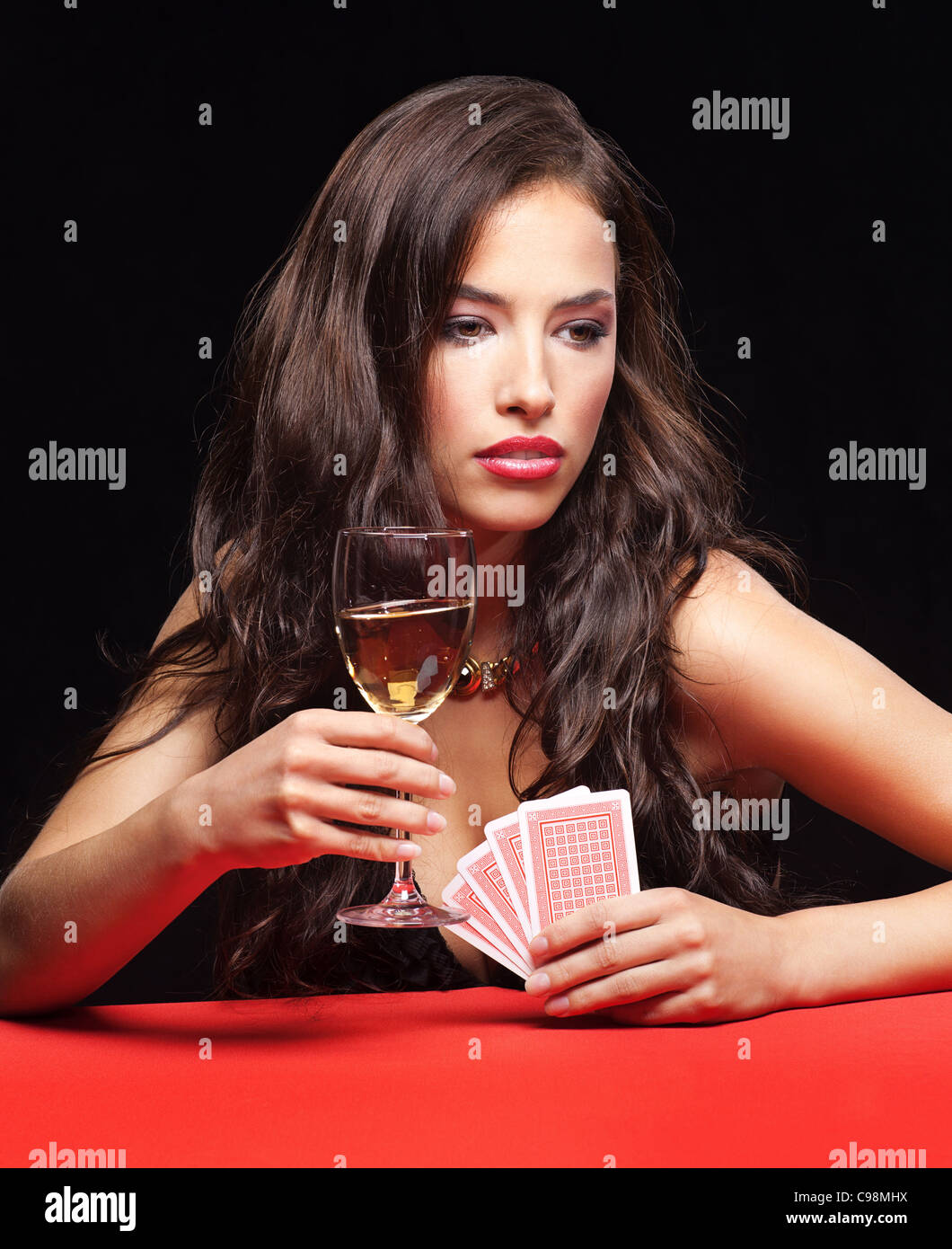 pretty young woman gambling on red table Stock Photo - Alamy