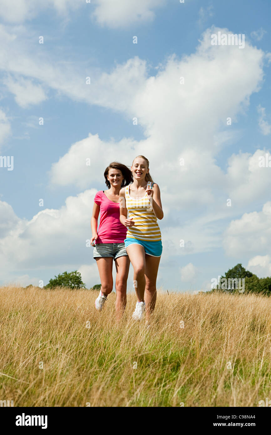 Female running through long grass hi-res stock photography and images ...