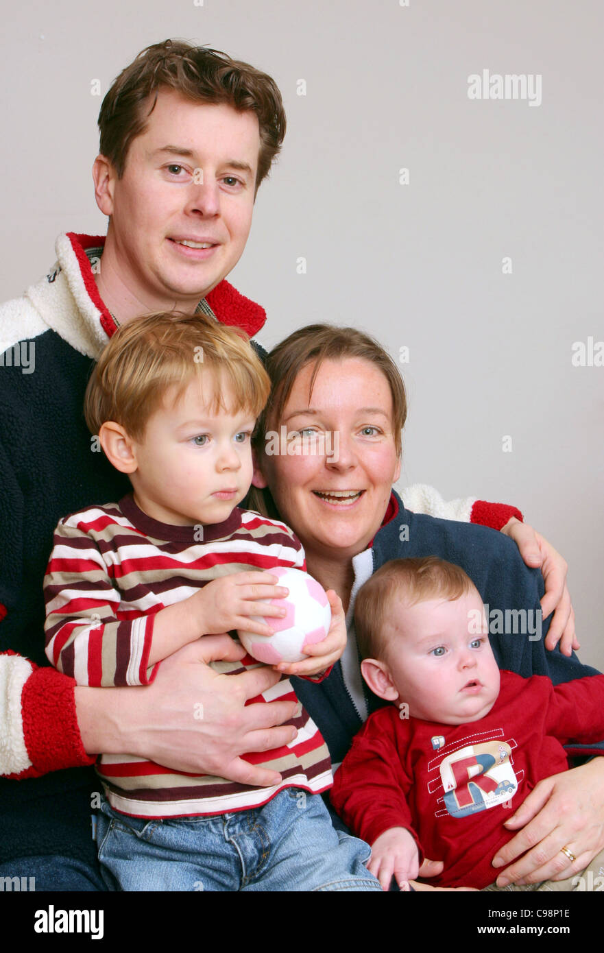Portrait of a happy common casual dressed family unit Stock Photo - Alamy