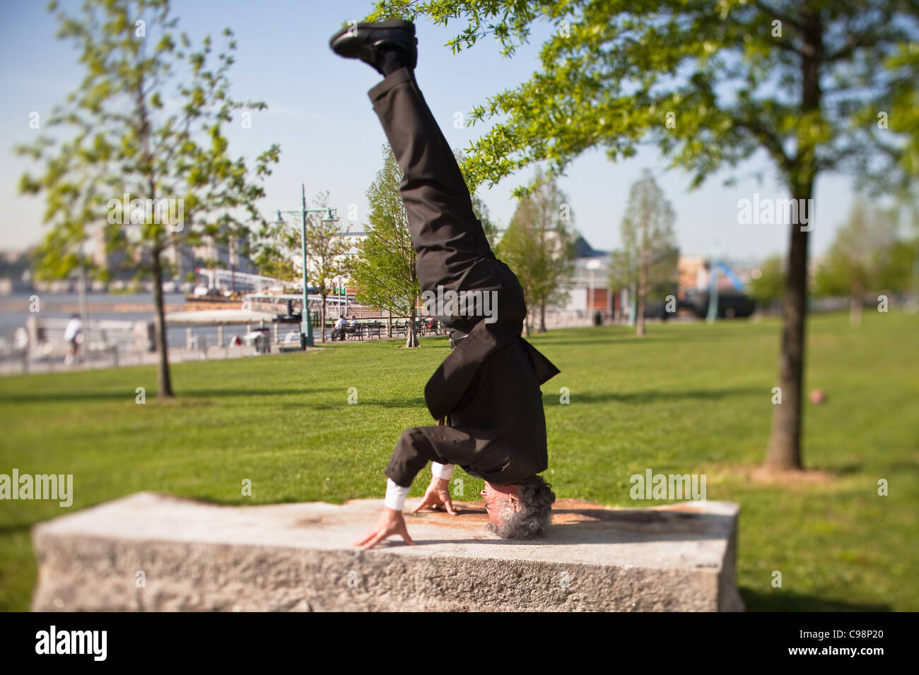 Senior man doing handstand park Stock Photo - Alamy