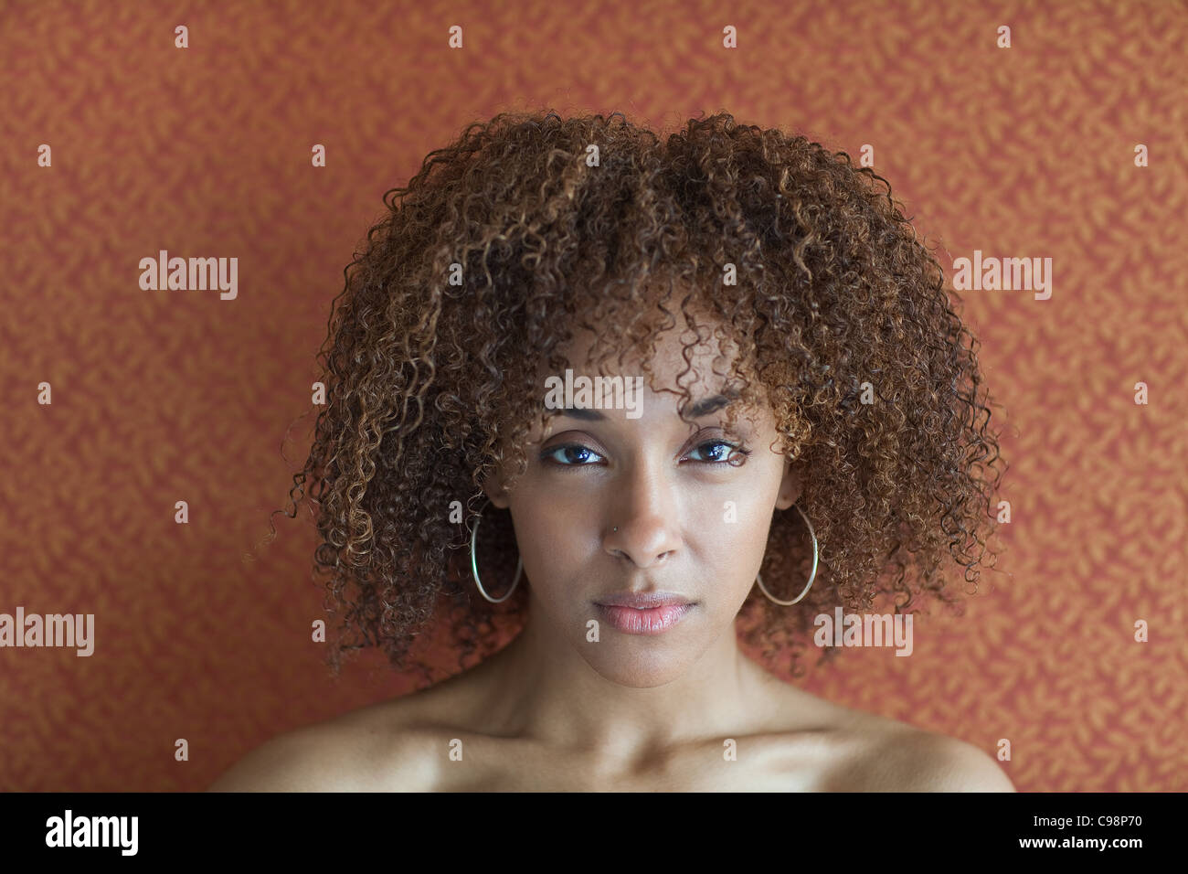 Portrait young woman looking sultry Stock Photo - Alamy