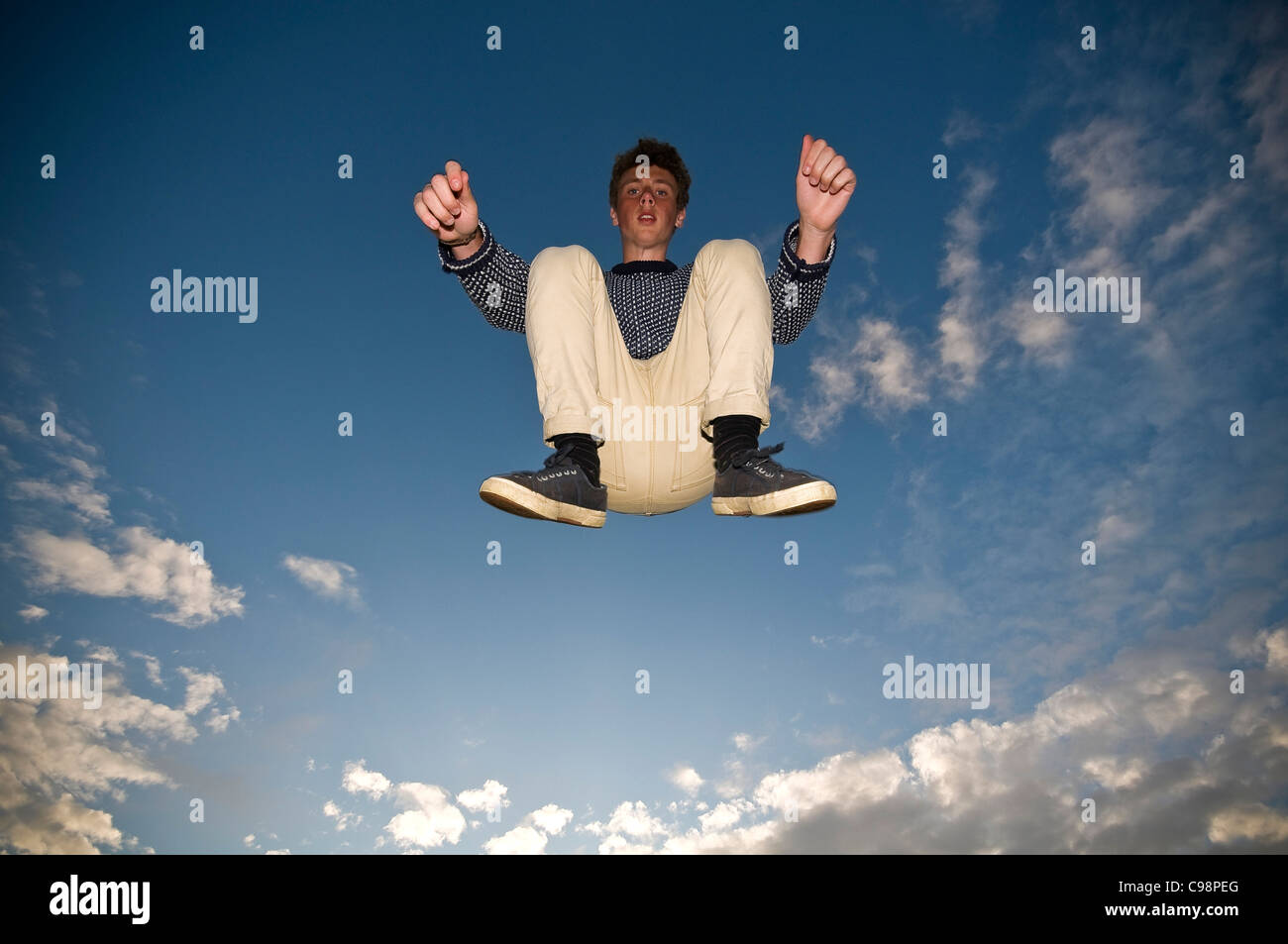 Young man leaping in the air viewed from beneath Stock Photo - Alamy