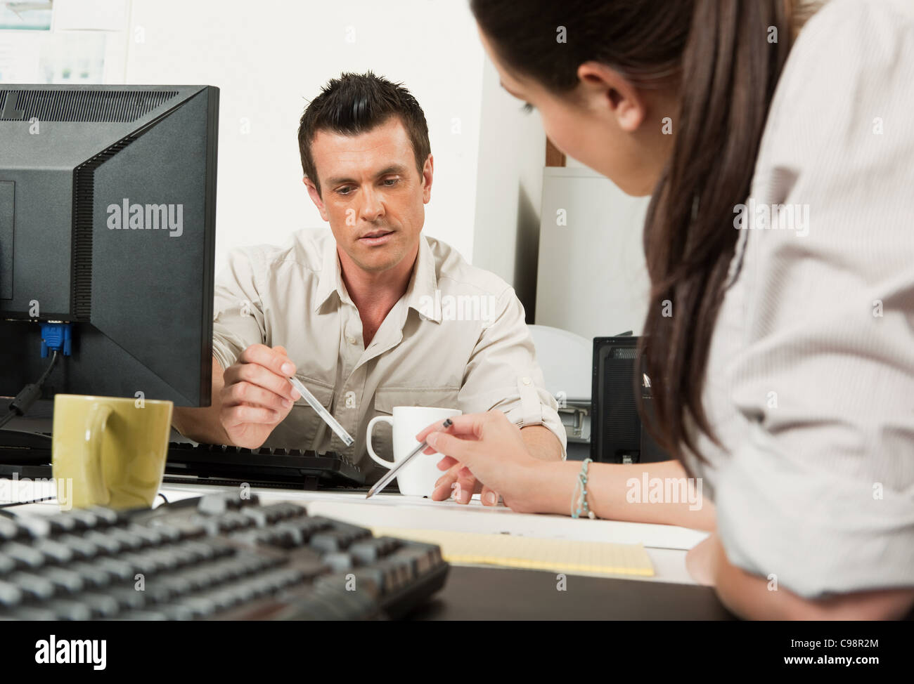 Colleagues reviewing work together Stock Photo - Alamy