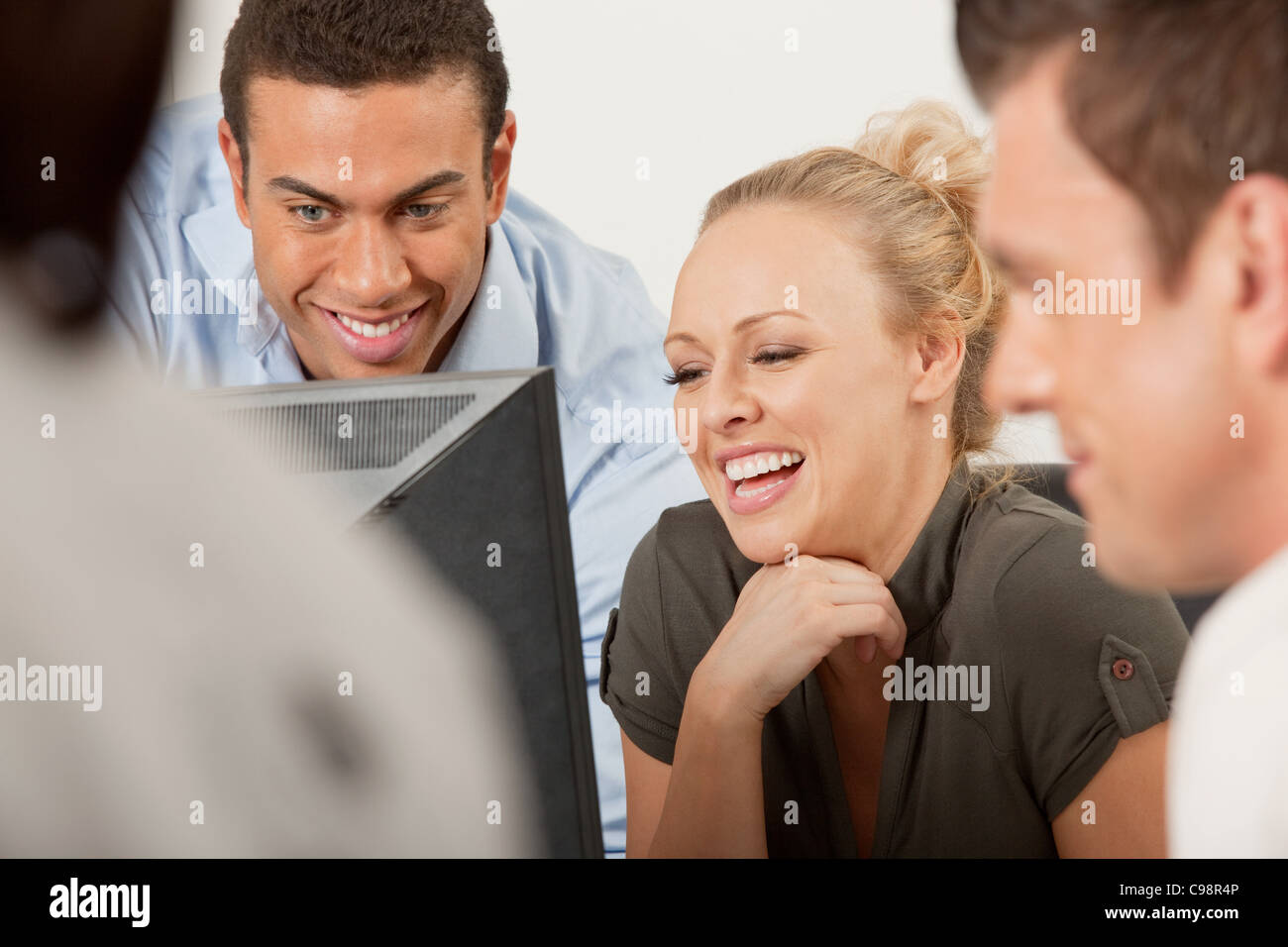Colleagues looking computer screen together Stock Photo - Alamy