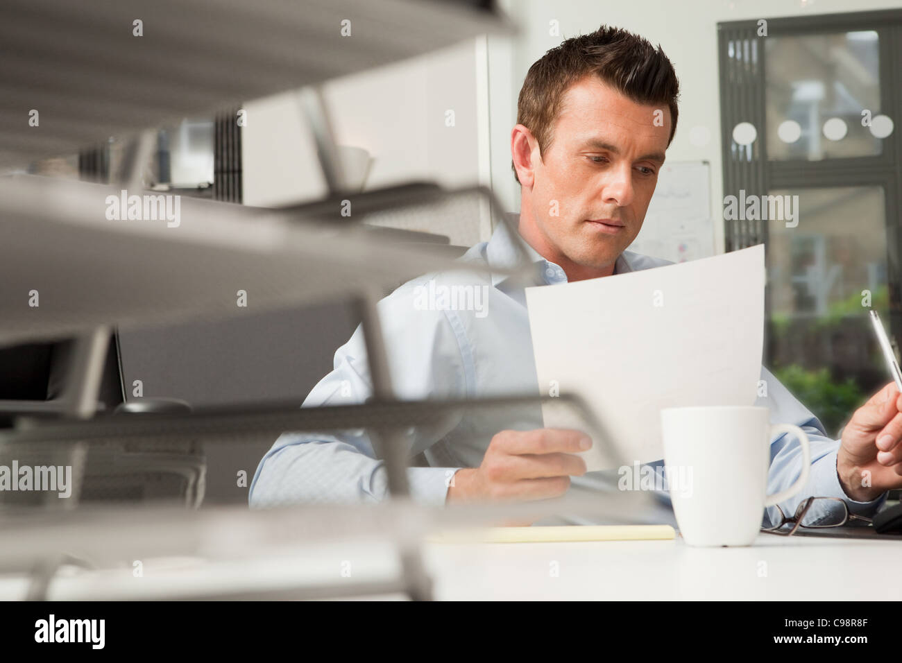 Office worker checking document Stock Photo - Alamy