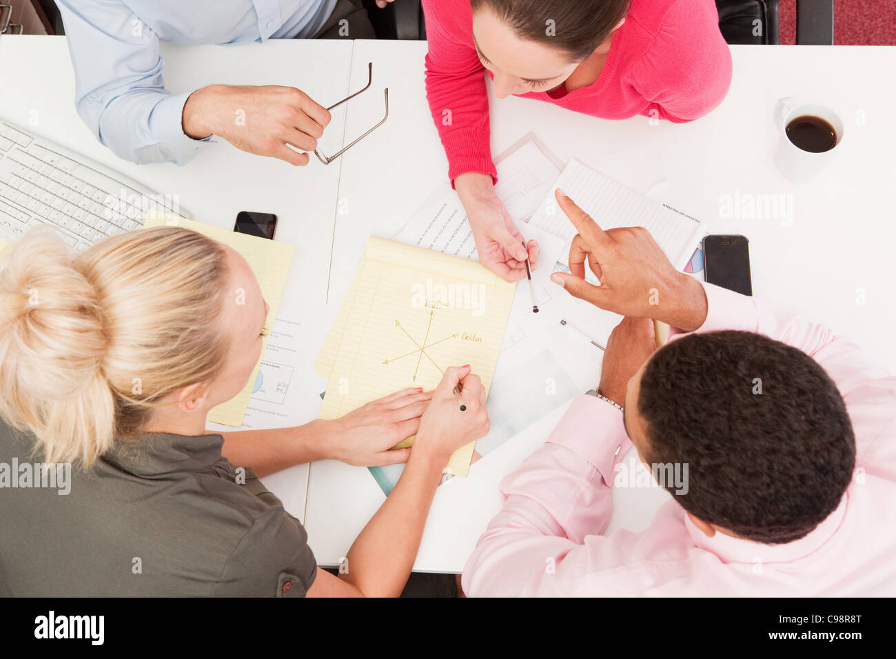 Four people informal meeting Stock Photo - Alamy