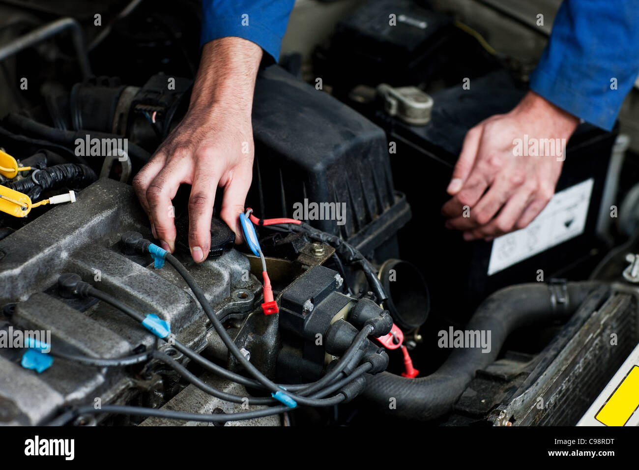 Mechanic fixing car engine Stock Photo - Alamy