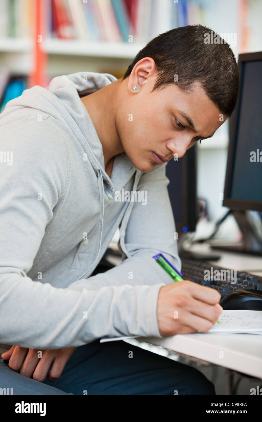 University student working computer desk Stock Photo - Alamy