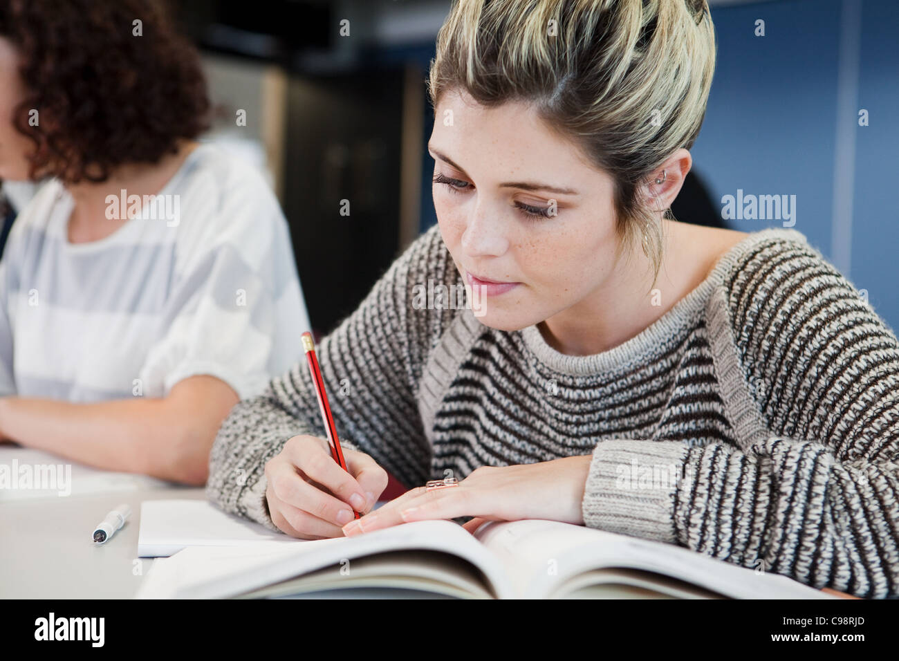 University student studying textbook class Stock Photo - Alamy