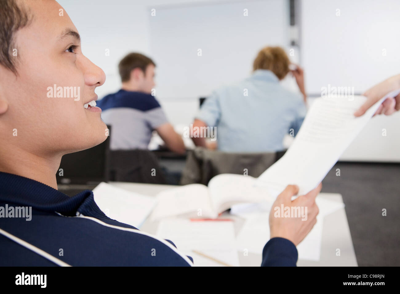 University student receiving exam paper Stock Photo - Alamy