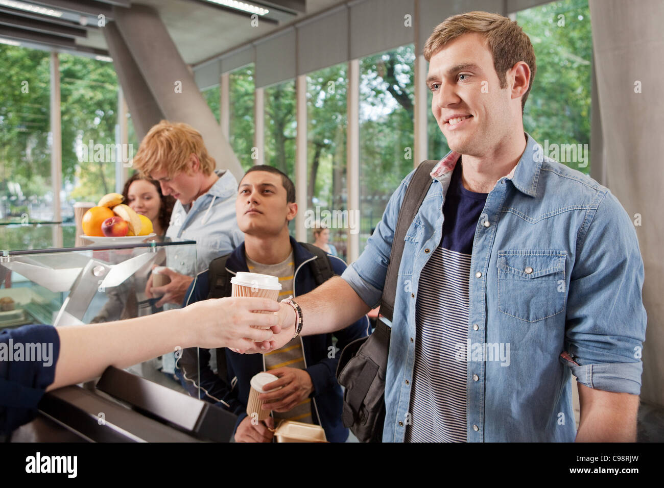 University student paying college cafe Stock Photo - Alamy