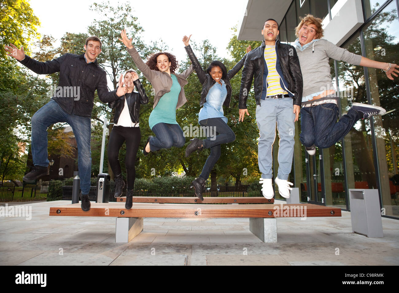 University students jumping college Stock Photo - Alamy