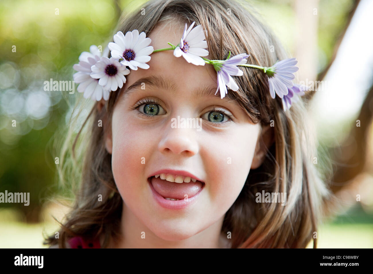 Young girl with daisy chain on head, portrait Stock Photo - Alamy