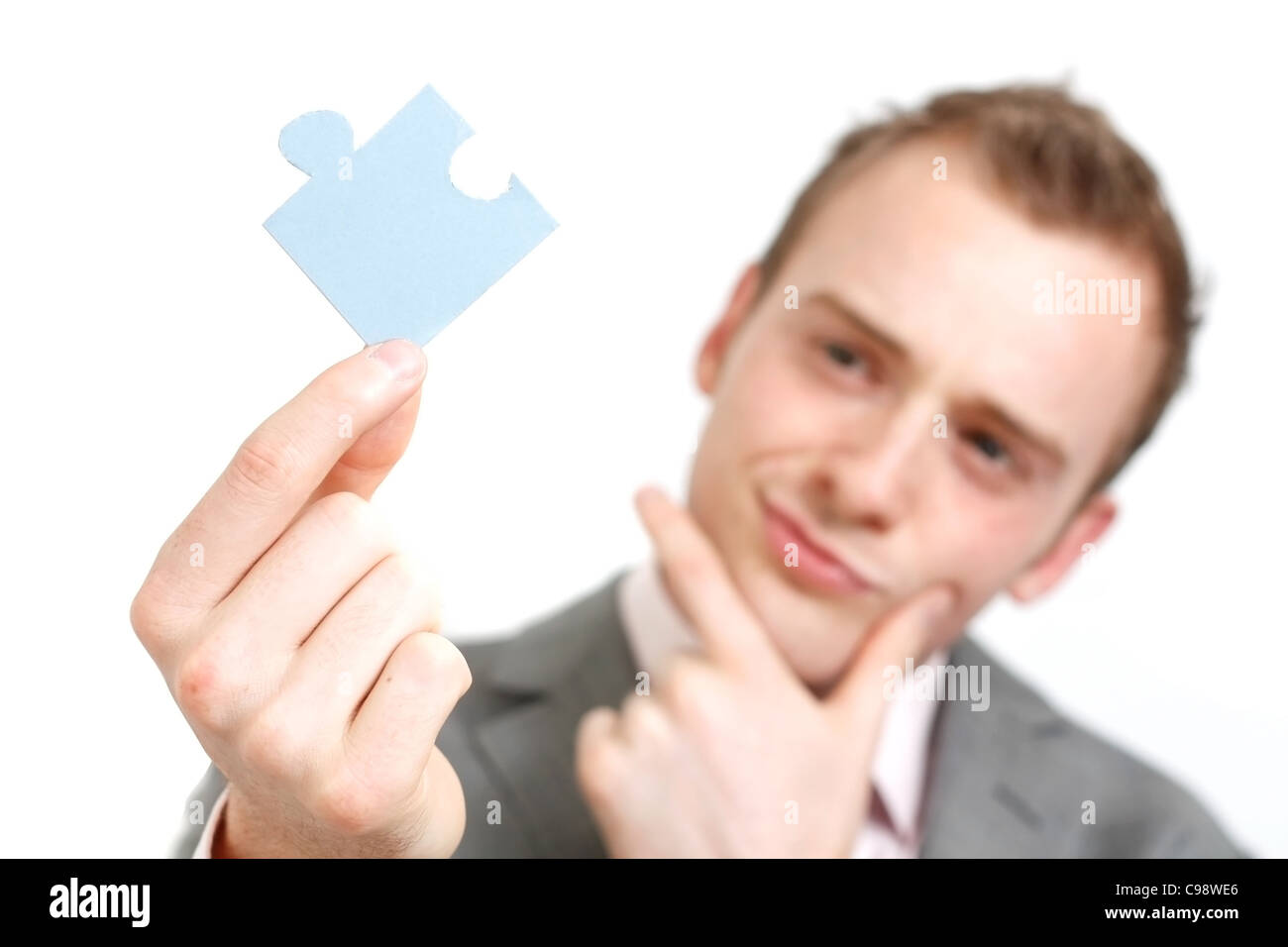 A business man solving a puzzle Stock Photo - Alamy
