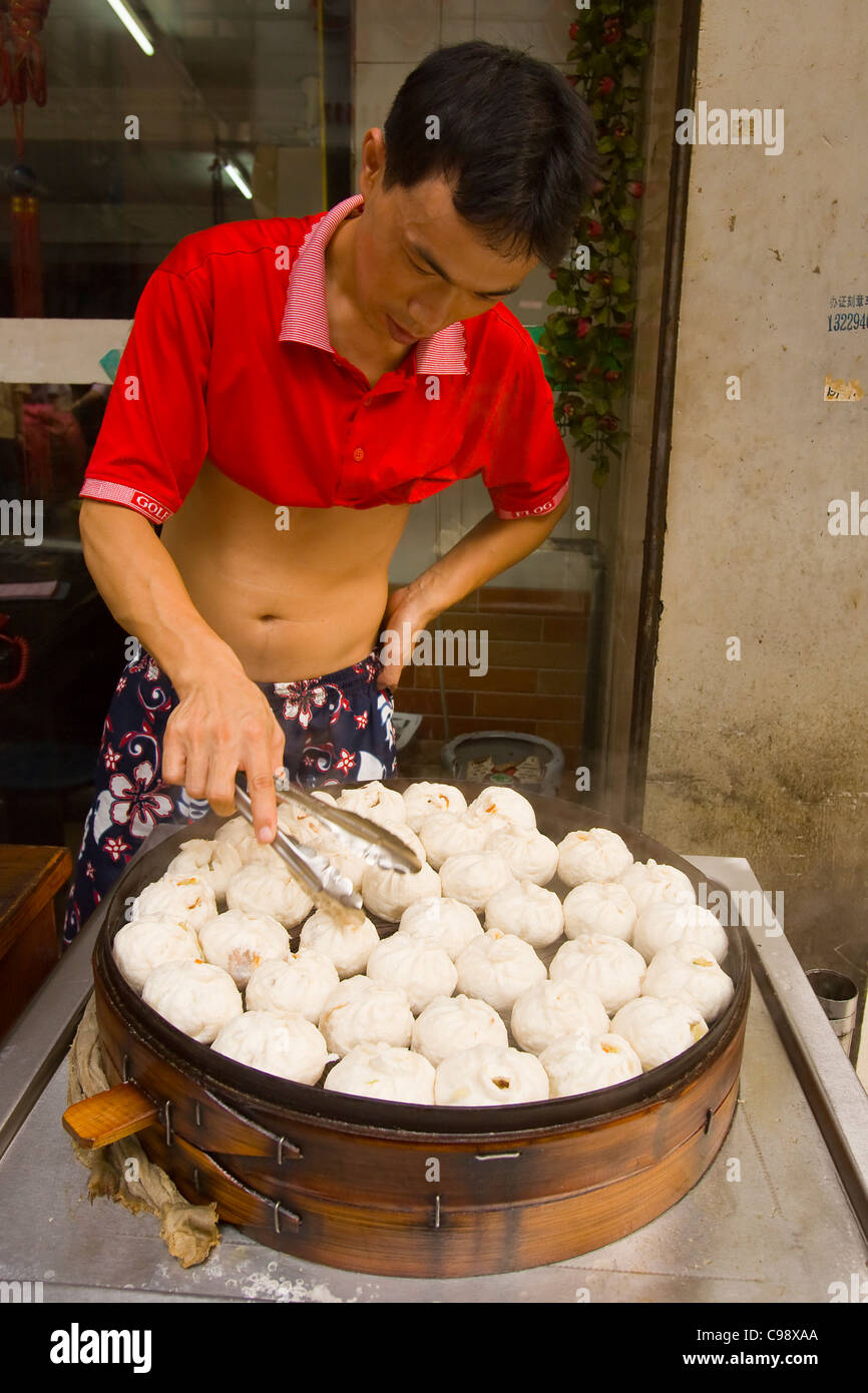 GUANGZHOU, GUANGDONG PROVINCE, CHINA - Man cooking dumplings at ...