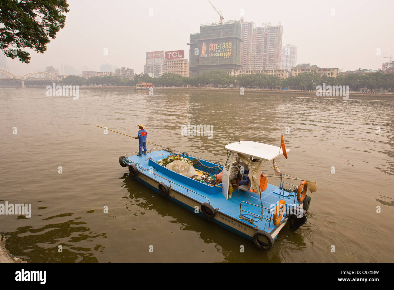 GUANGZHOU, GUANGDONG PROVINCE, CHINA - Trash collection boat on river ...