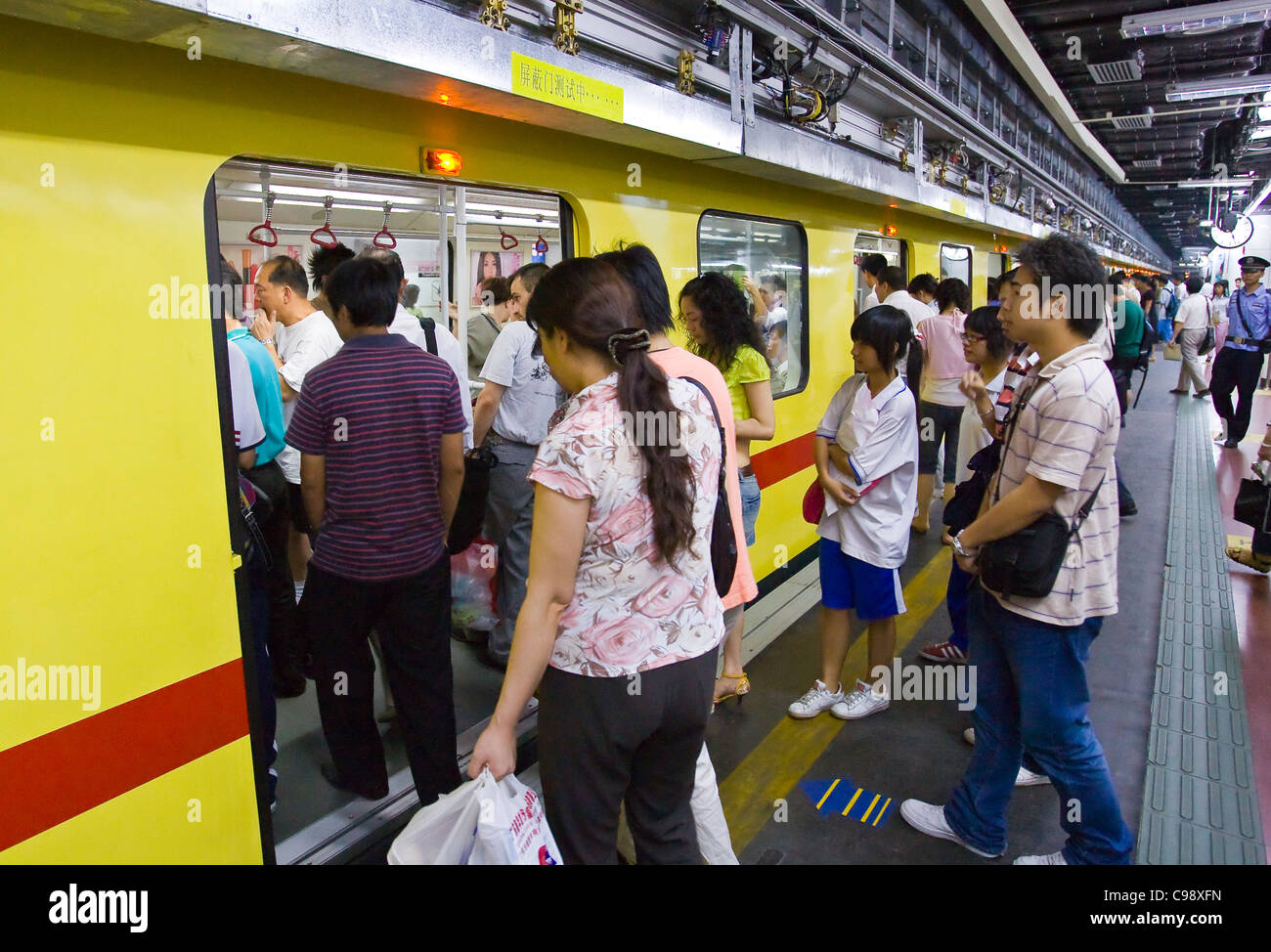GUANGZHOU, GUANGDONG PROVINCE, CHINA - Passengers boarding subway ...