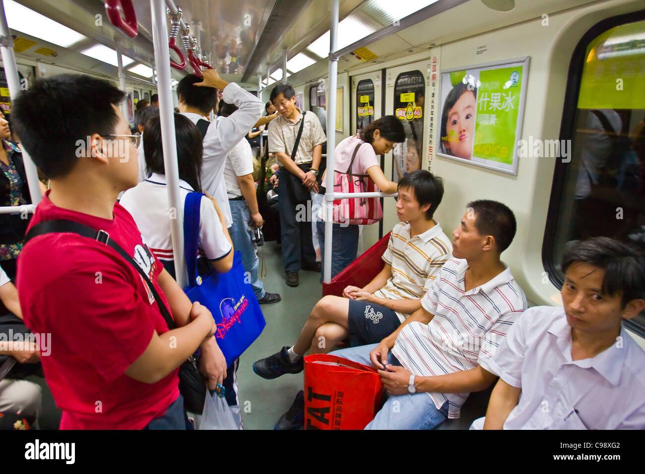 GUANGZHOU, GUANGDONG PROVINCE, CHINA - Passengers riding in subway ...