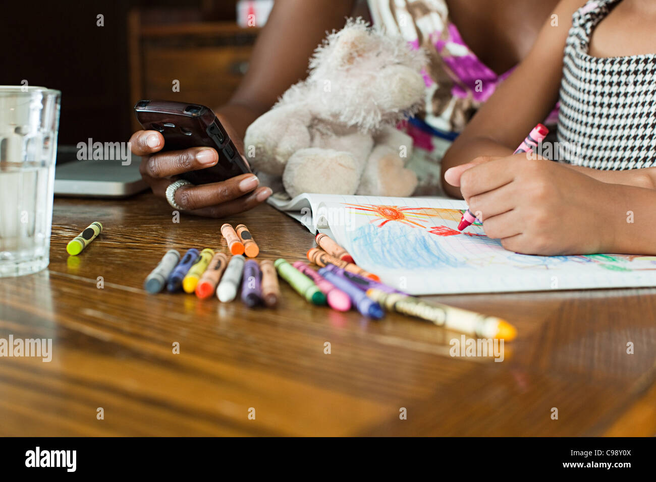 Girl drawing with crayons Stock Photo - Alamy
