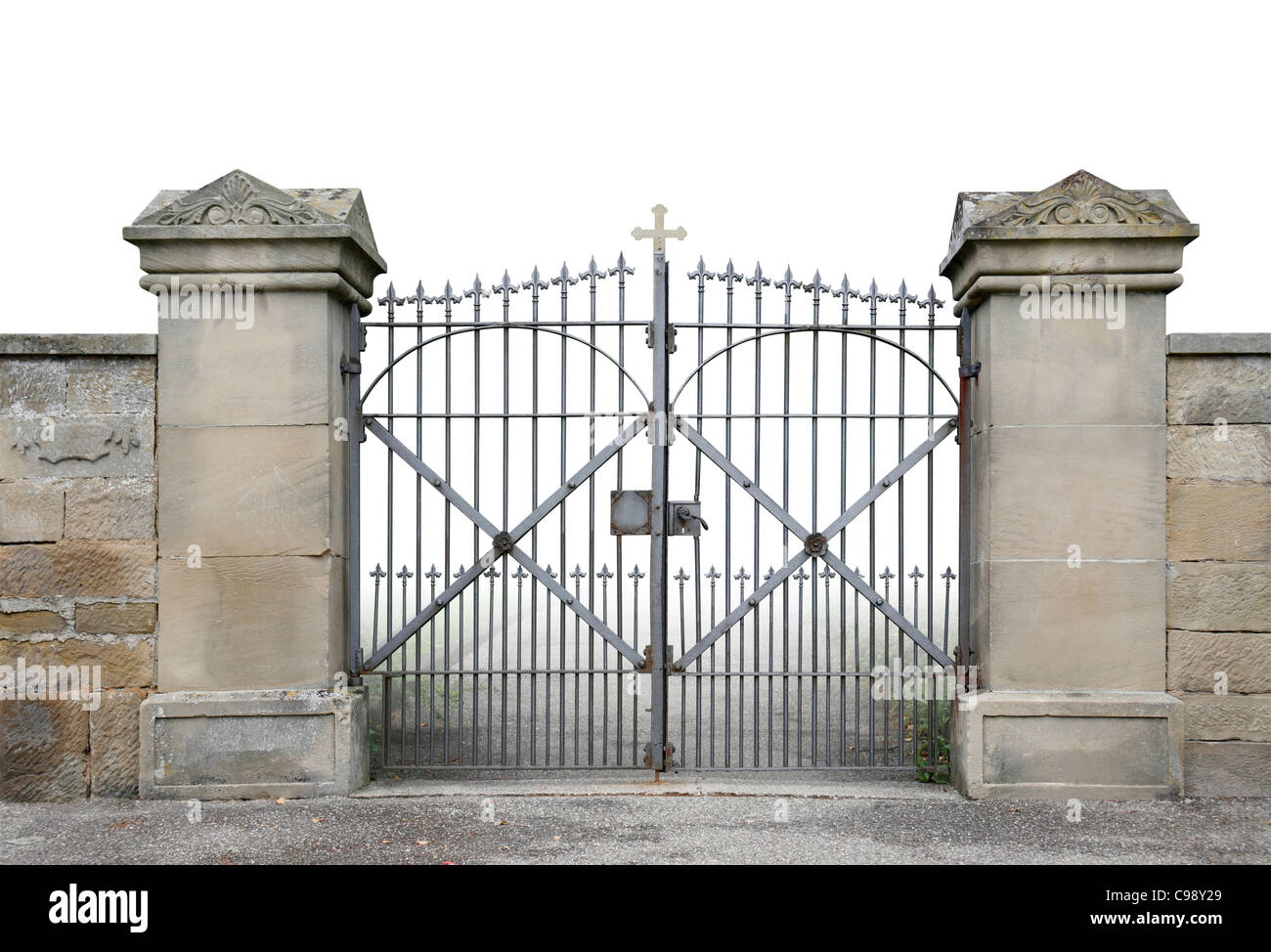 entrance of a graveyard with a wrought-iron gate and stone wall detail ...