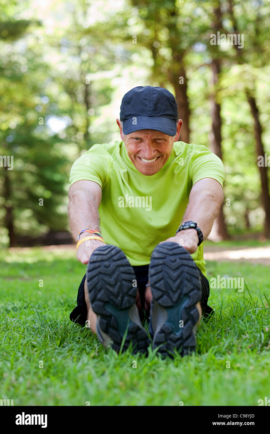 Man stretching on grass Stock Photo - Alamy