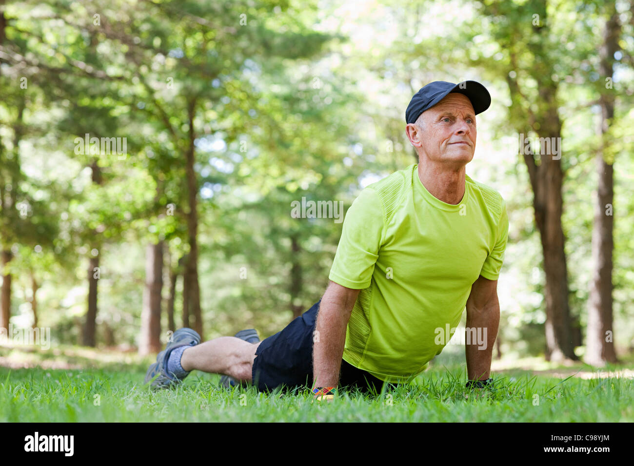 Man stretching on grass Stock Photo - Alamy