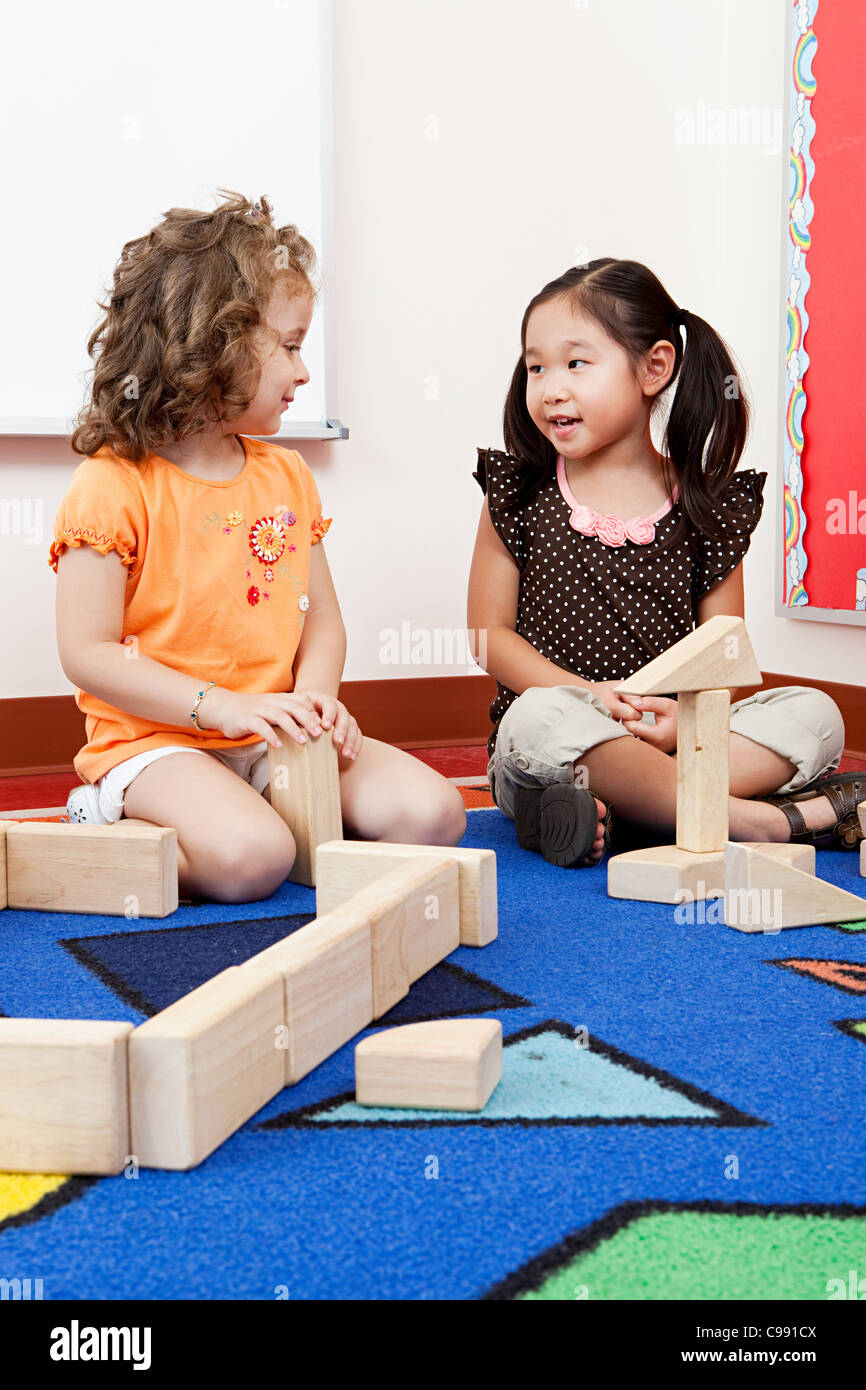 Two girls with building blocks Stock Photo - Alamy
