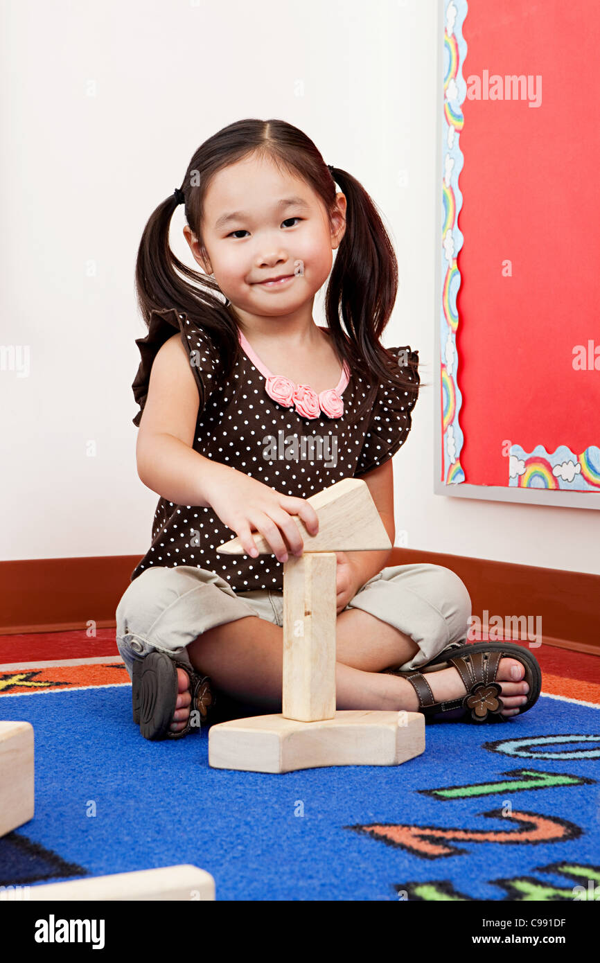 Girl playing with building blocks Stock Photo - Alamy