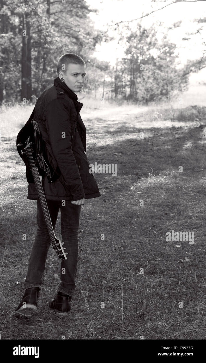 teen musician with a guitar in the autumn forest Stock Photo - Alamy