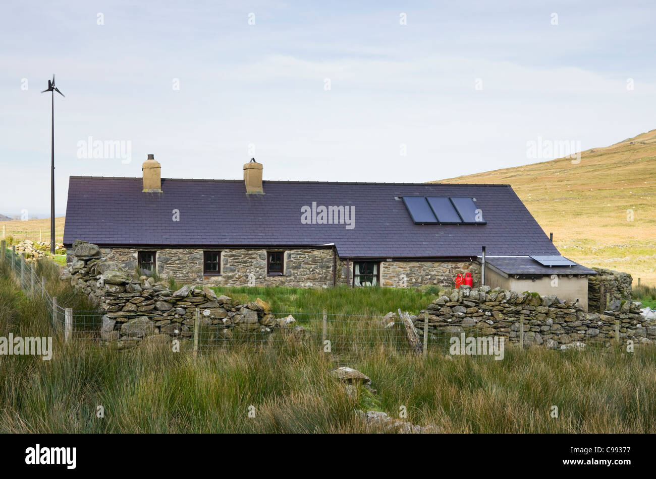 Remote rural cottage with solar panels on roof for heating water and ...