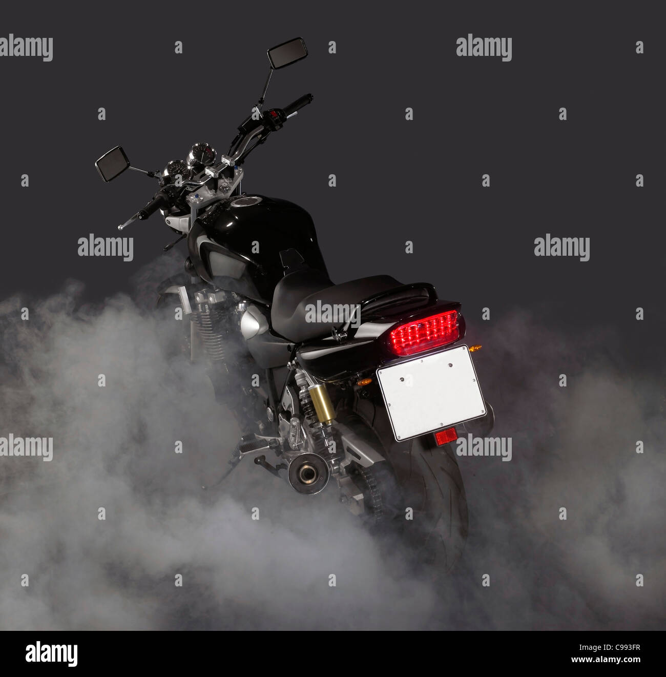 detail of a motorbike and lots of smoke in dark back Stock Photo - Alamy