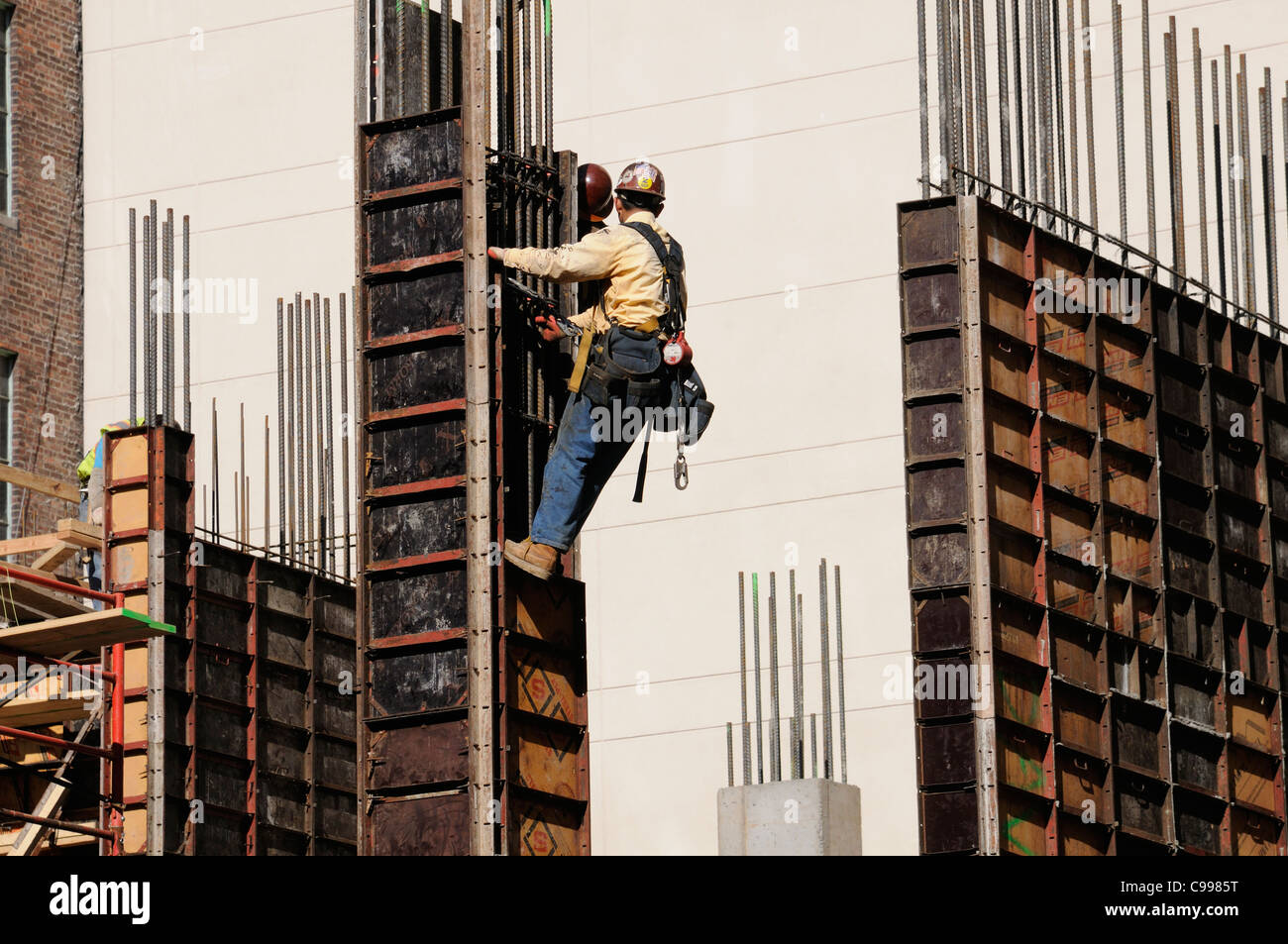 Construction worker wearing safety harness on a New York building site ...