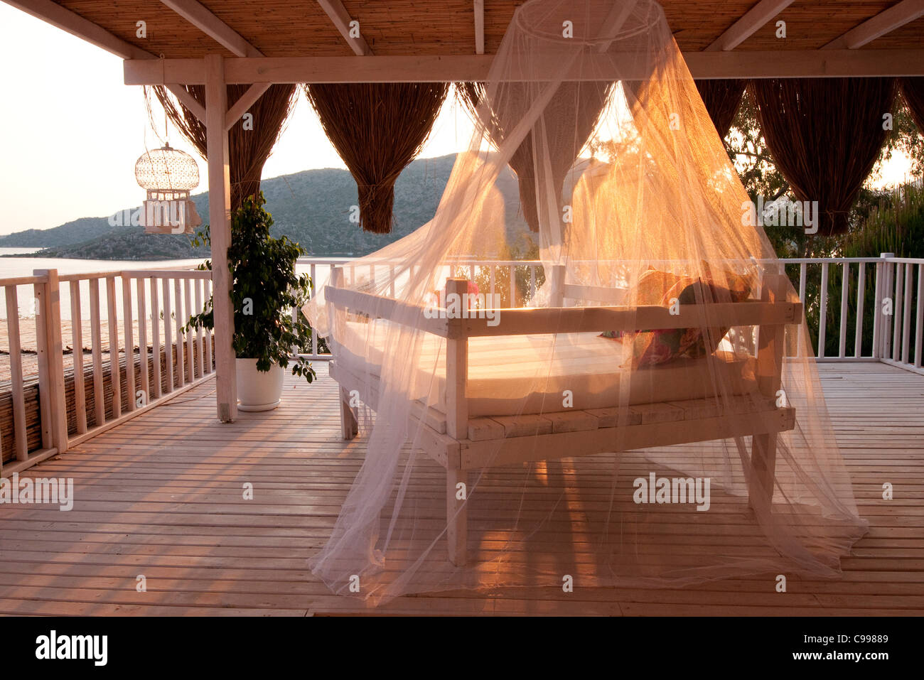 Bed on deck of Karia Bel' Hotel room at sunset, Bozburun, Turkey Stock ...