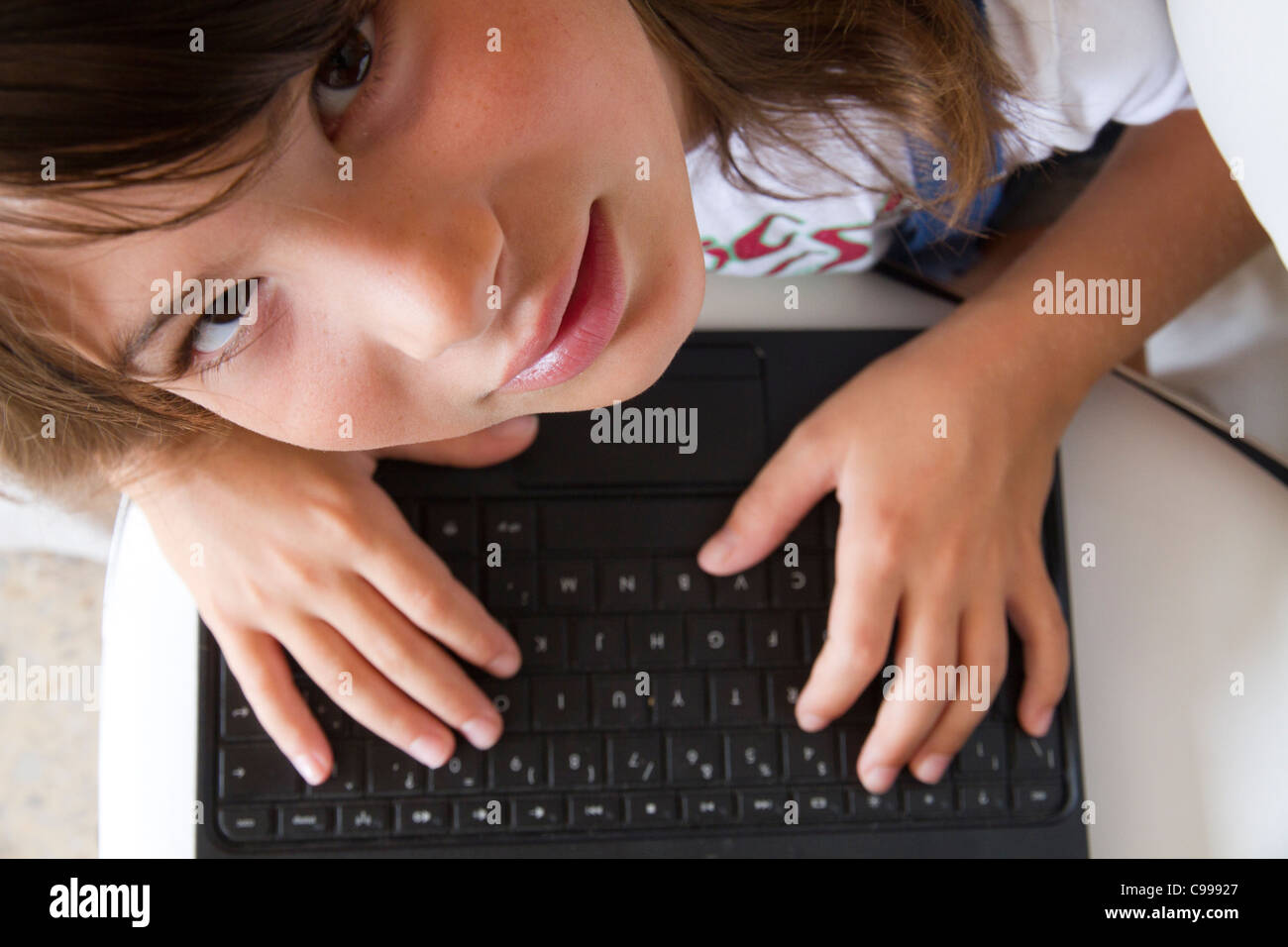 Girl looking at camera using computer laptop Stock Photo - Alamy