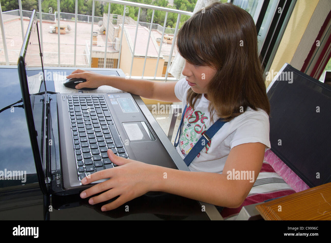 Girl using on notebook laptop computer monitor Stock Photo - Alamy