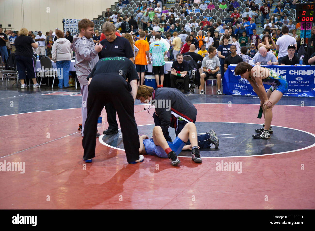 Medical doctor looks at injured wrestler at Tournament of Champions ...