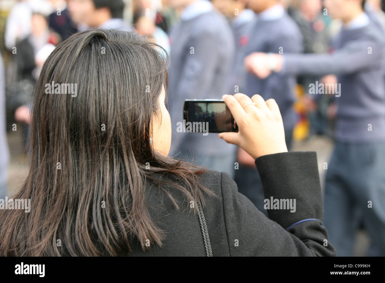 woman filming on a mobile phone Stock Photo - Alamy
