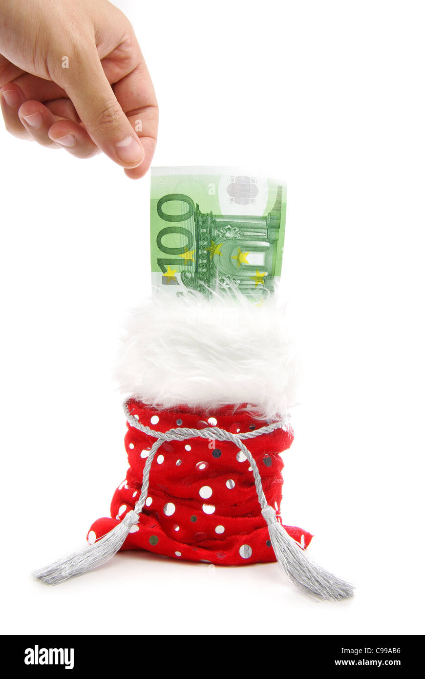 a hand aiming to take a bank note from a red present-bag isolated on a ...