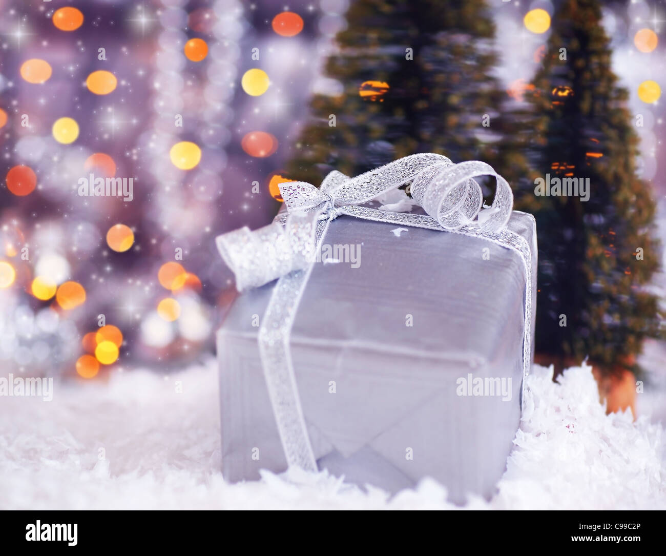Winter holiday background with present gift box, silver ribbon ornament ...